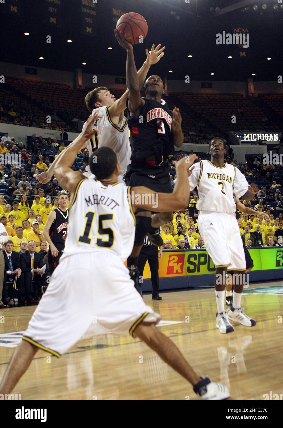Northeastern guard Chaisson Allen (3) makes a layup, defended by ...