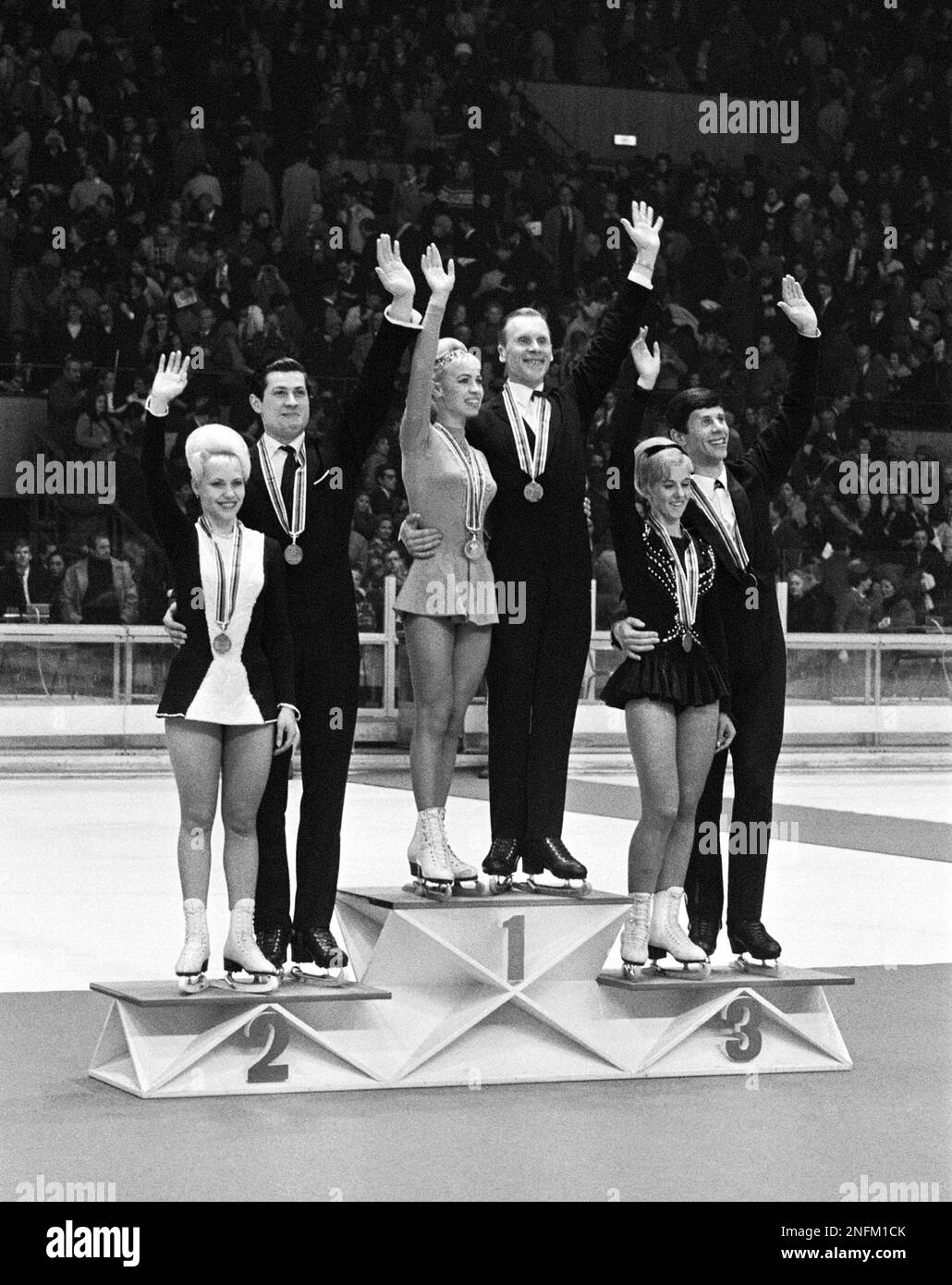 Olympic pairs figure skating medalists stand on the podium at the medal ...