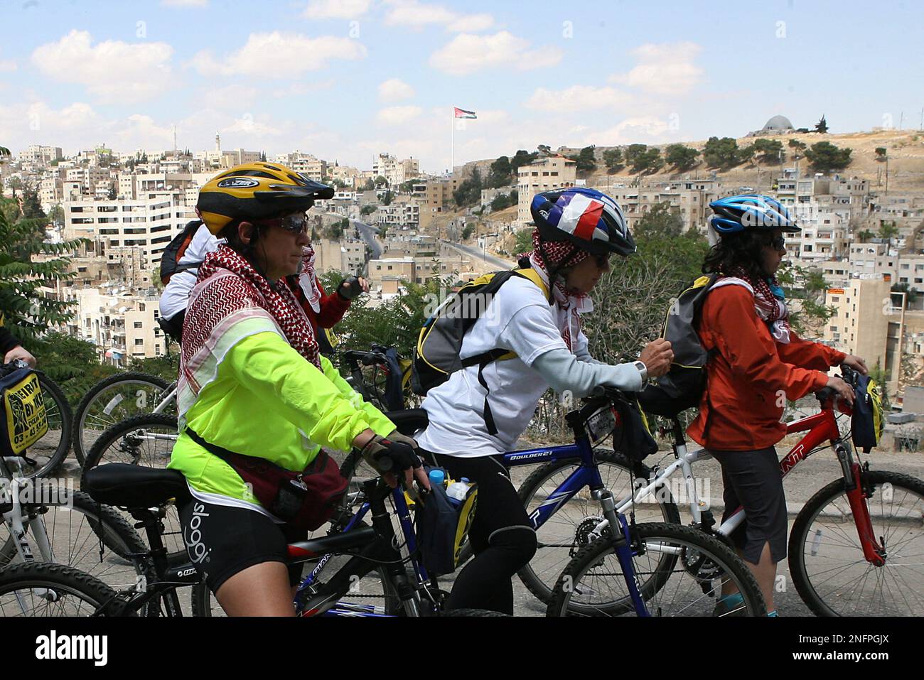 Participants take part in the Middle East cycle tour for peace in Amman ...