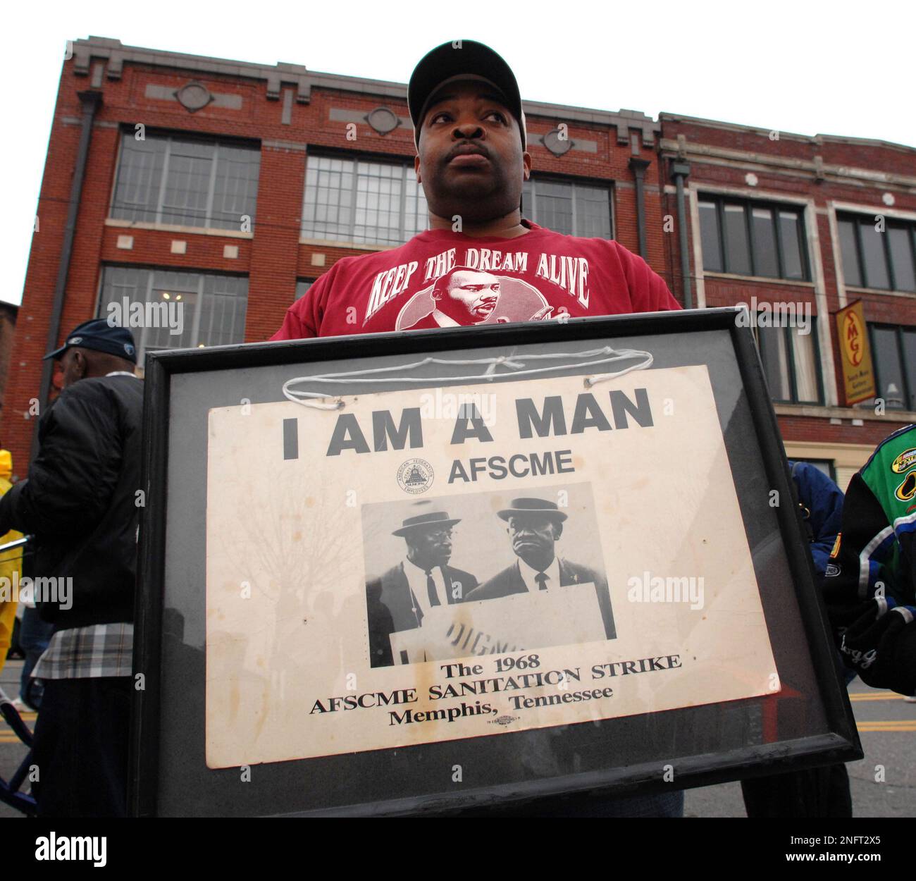 Tim Waiters holds his uncle Jimmy's original sign from the sanitation ...