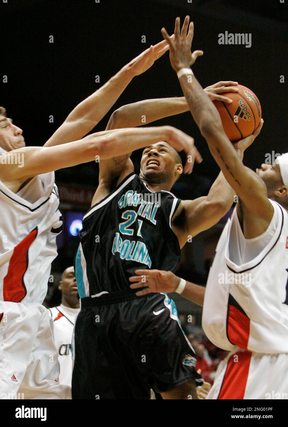 Coastal Carolina forward Phil Wallace (21) shoots between Cincinnati ...