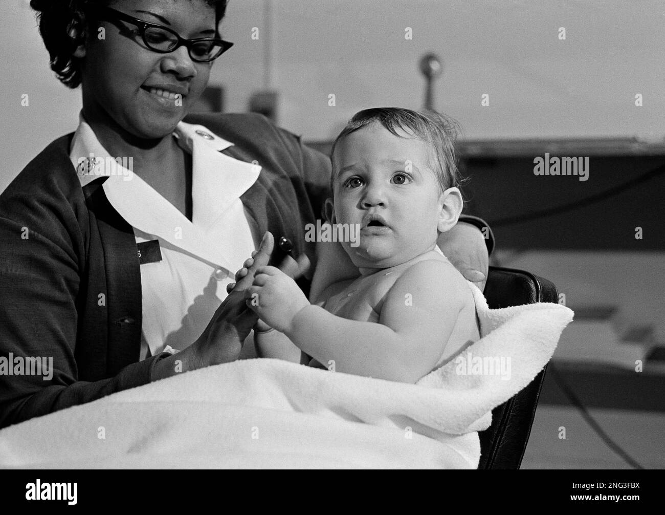 Emily Morrison, an 18 month old baby, rests in the arms of Loretta ...