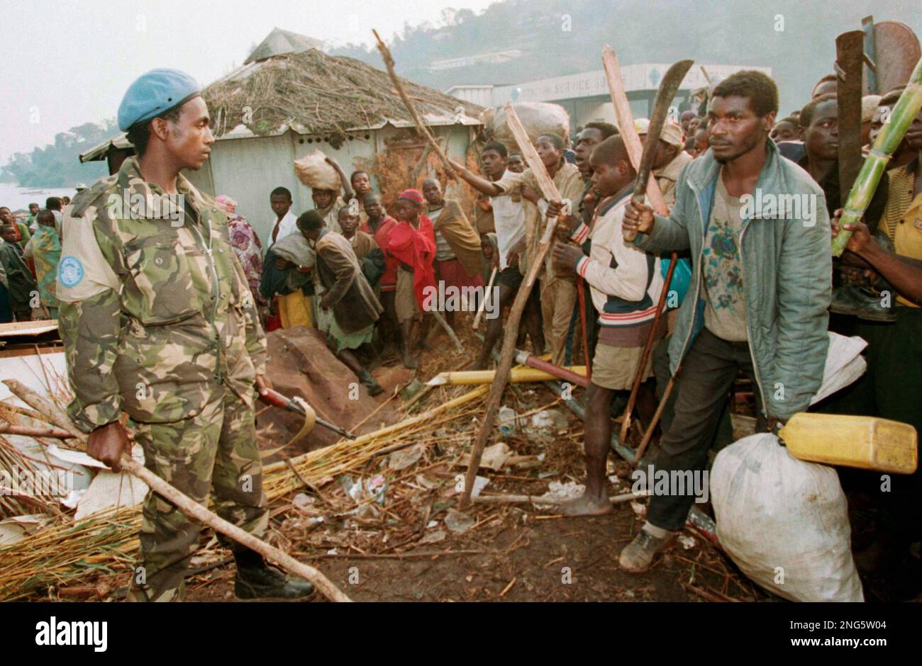 A United Nations Ethiopian soldier faces a crowd of Rwandan refugees ...