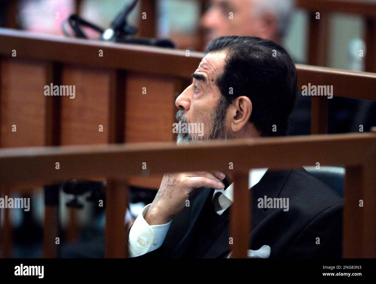 Former Iraqi president Saddam Hussein listens during his trial in the ...
