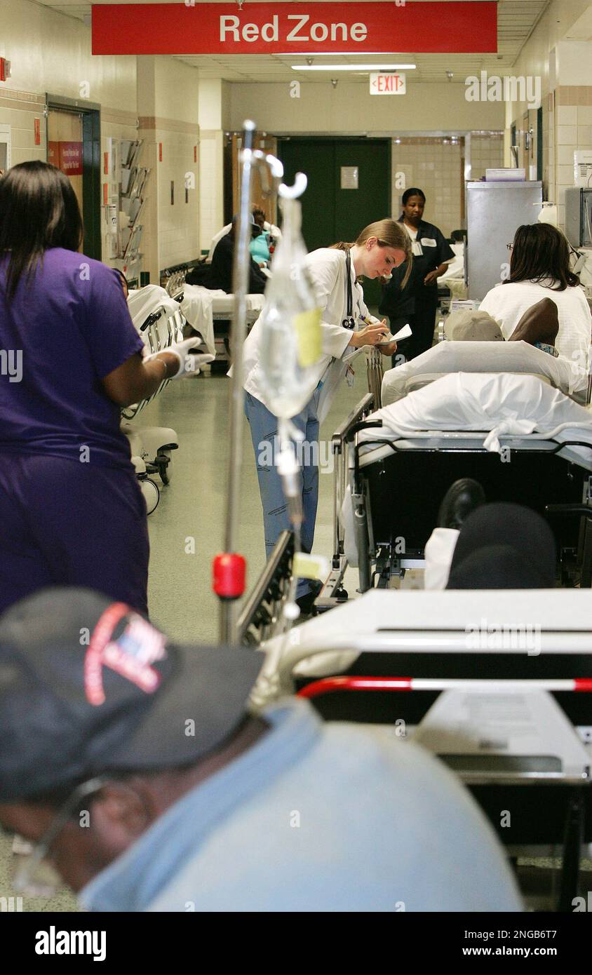 Gurneys, patients and staff members fill the hallway in the Red Zone ...