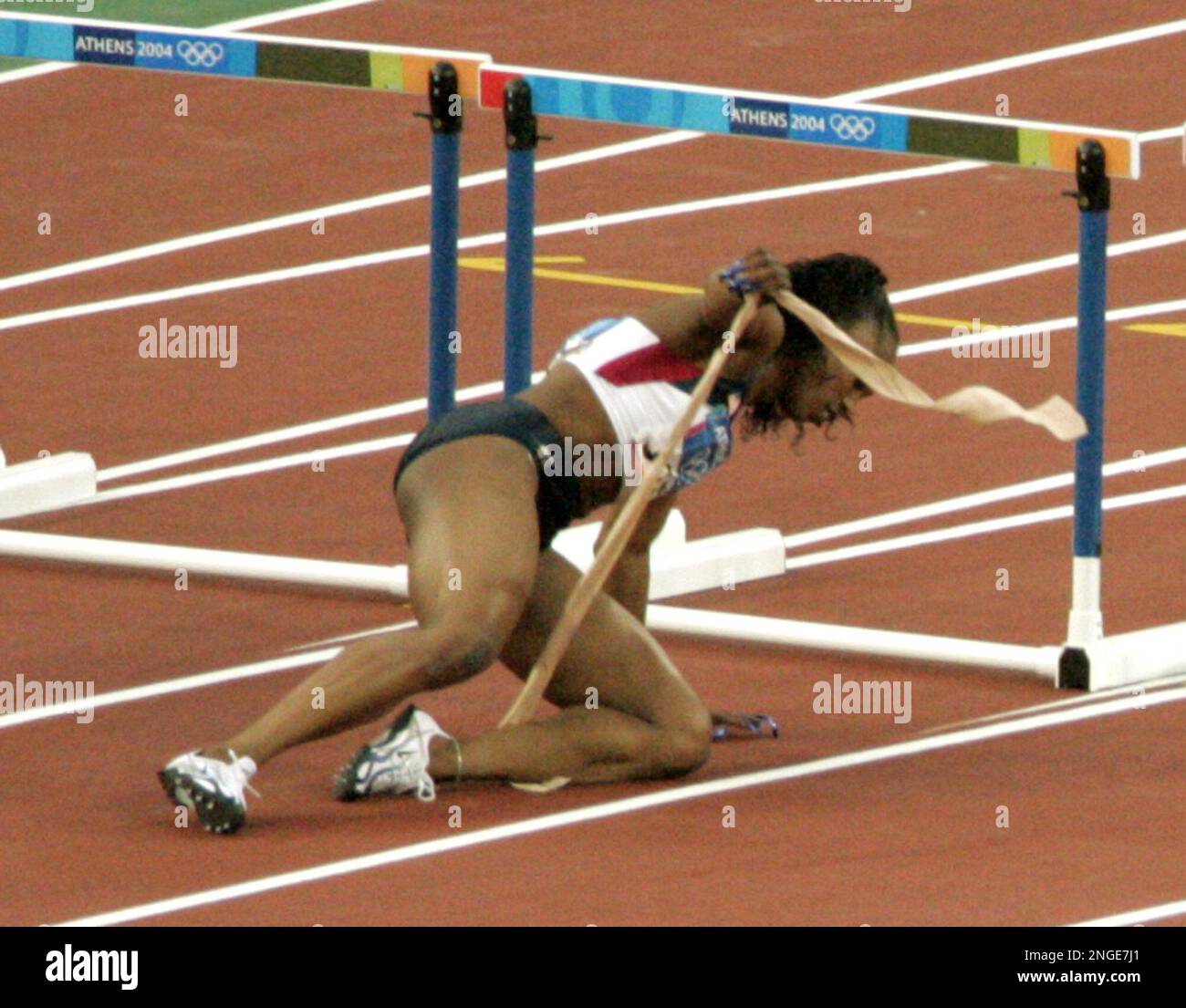 Gail Devers, of the United States, removes a bandage from her leg after ...