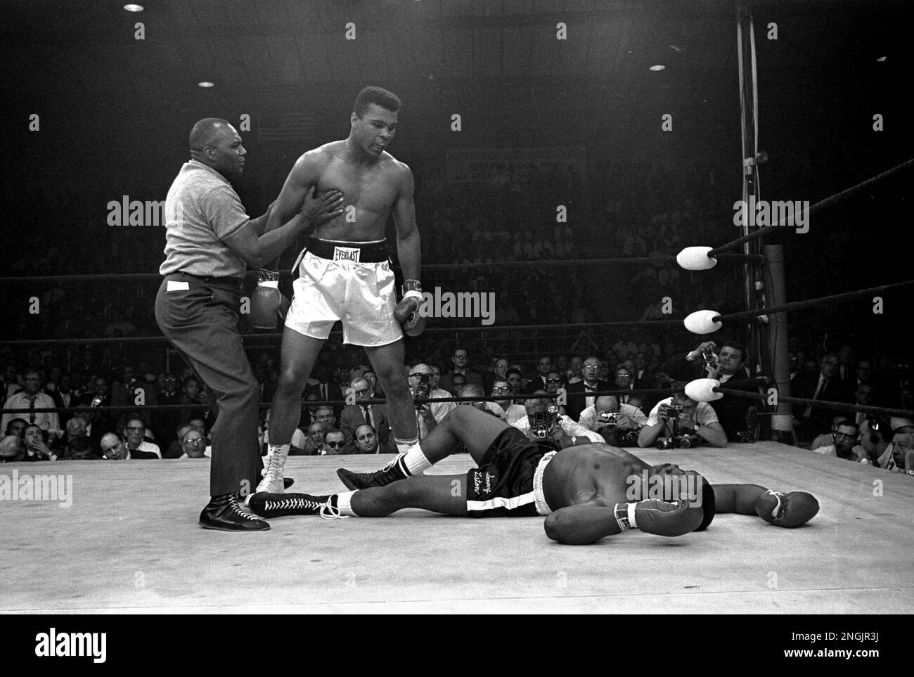 Heavyweight champion Muhammad Ali is shown standing over challenger ...