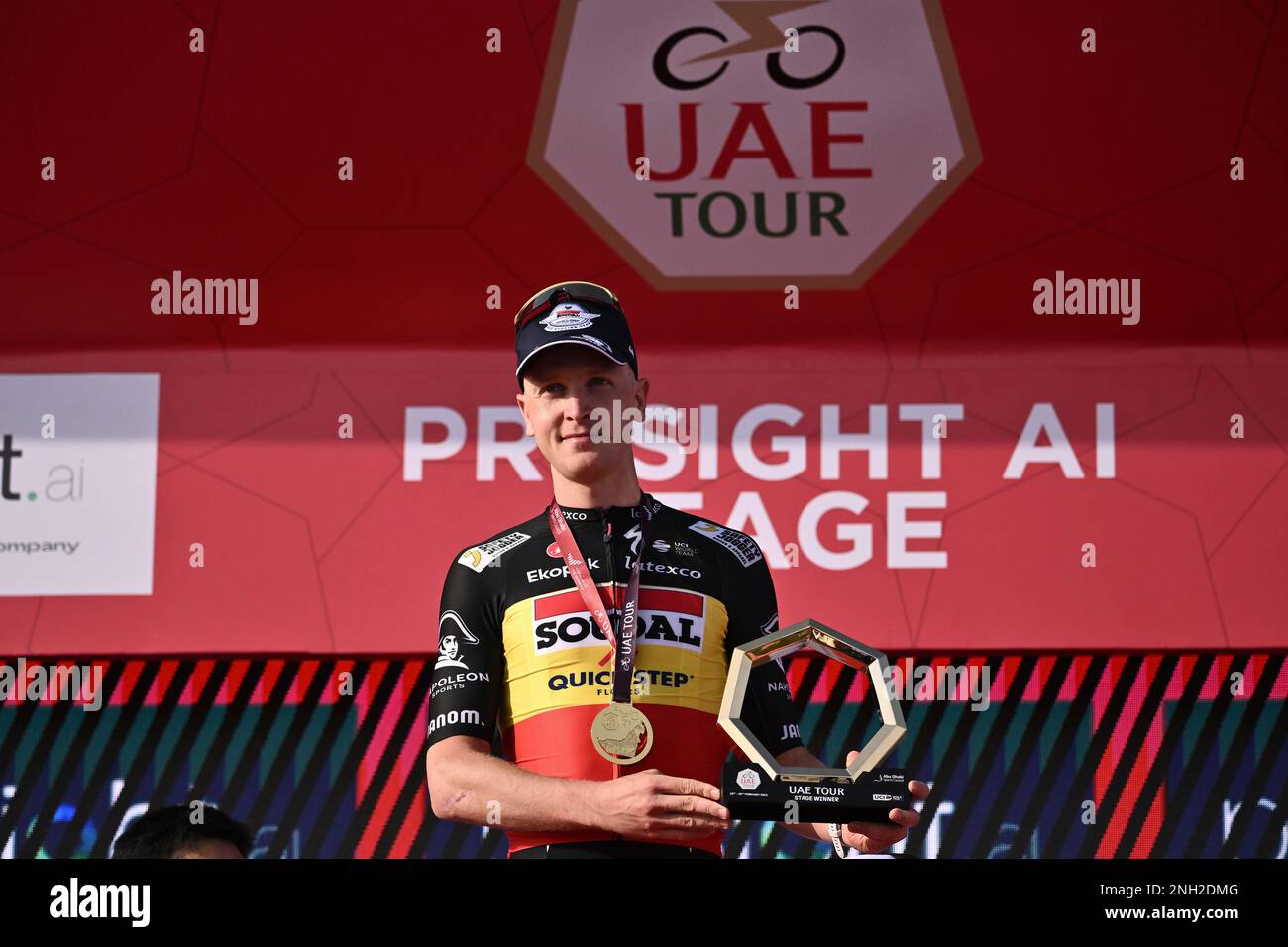 Belgium's Tim Merlier poses on podium after winning the opening stage ...