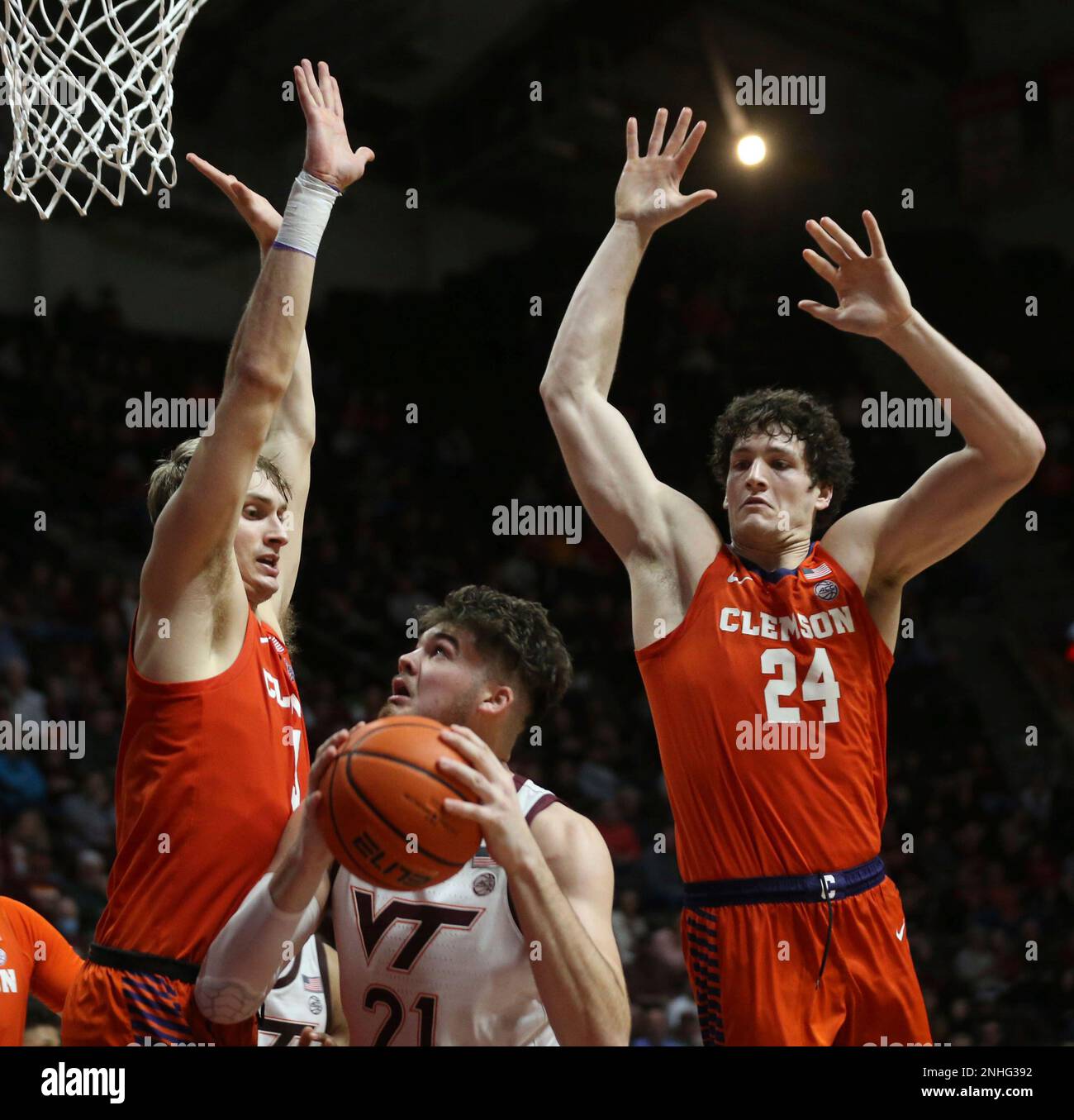 Virginia Tech's Grant Basile (21) center, is defended by Clemson's ...