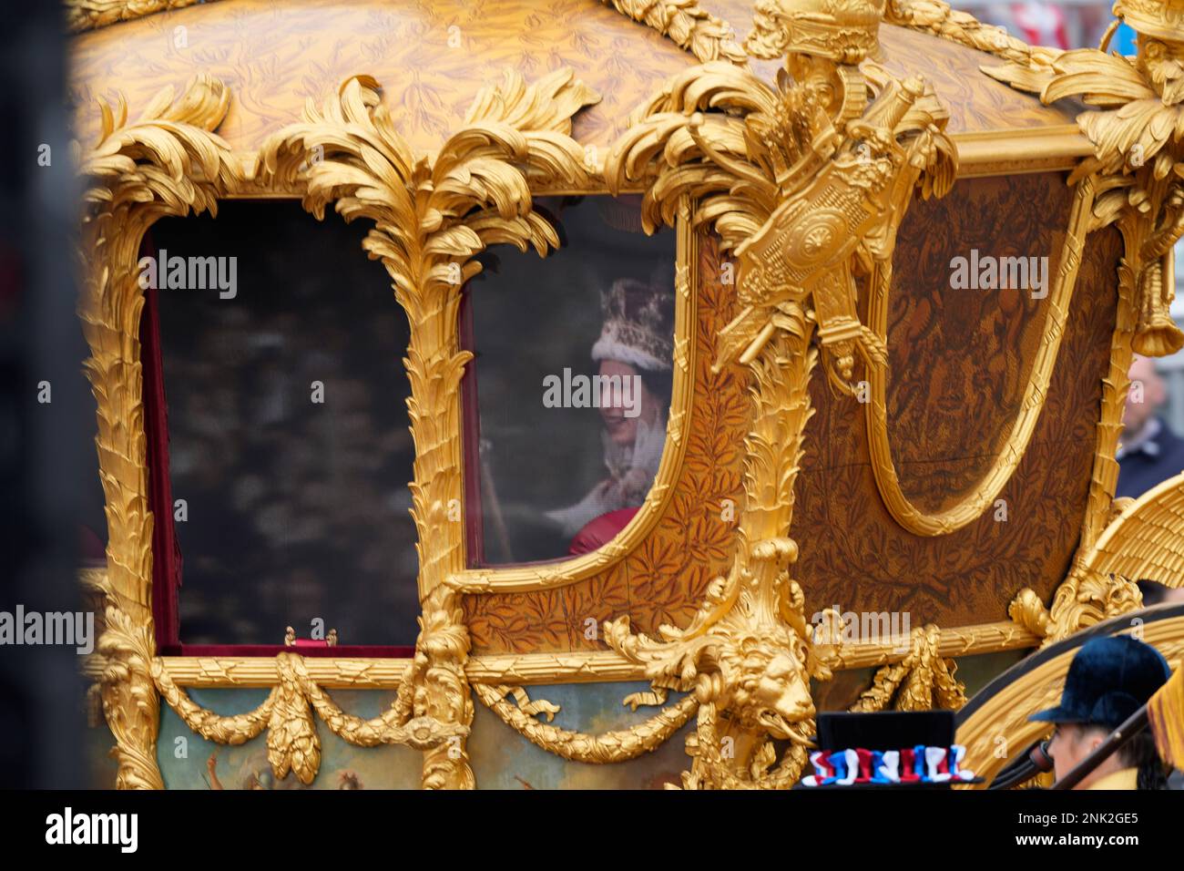 The image of Queen Elizabeth II is seen in a golden carriage during the ...