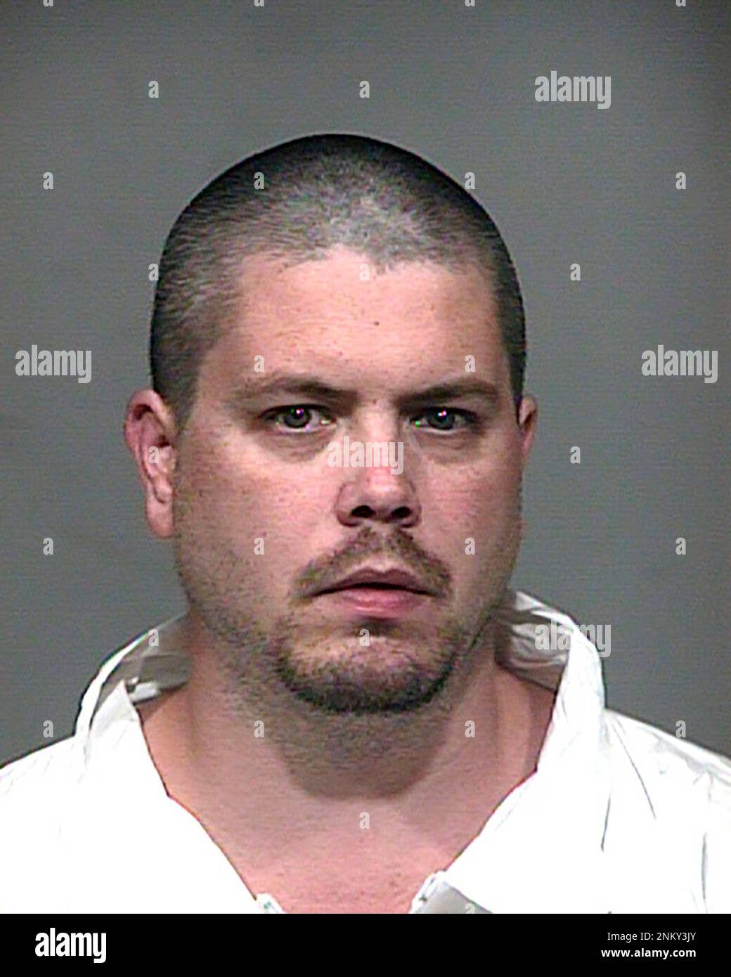 This undated Scottsdale Police Department booking image shows suspect Thomas James Desharnais in ...