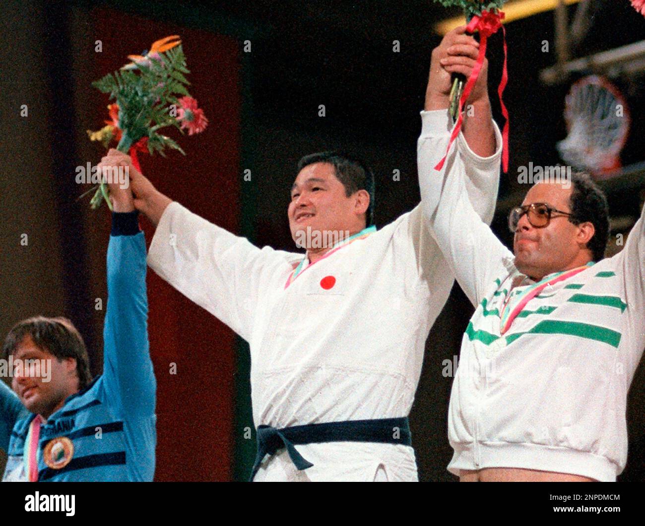 Japan's Yasuhiro Yamashita, center, celebrates winning gold medal at a ...