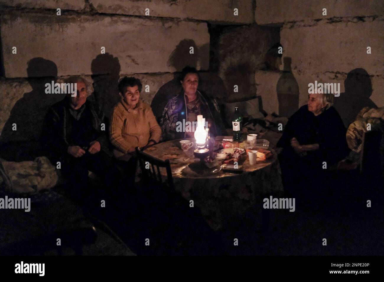 People sit in a bomb shelter during a military conflict in Stepanakert ...