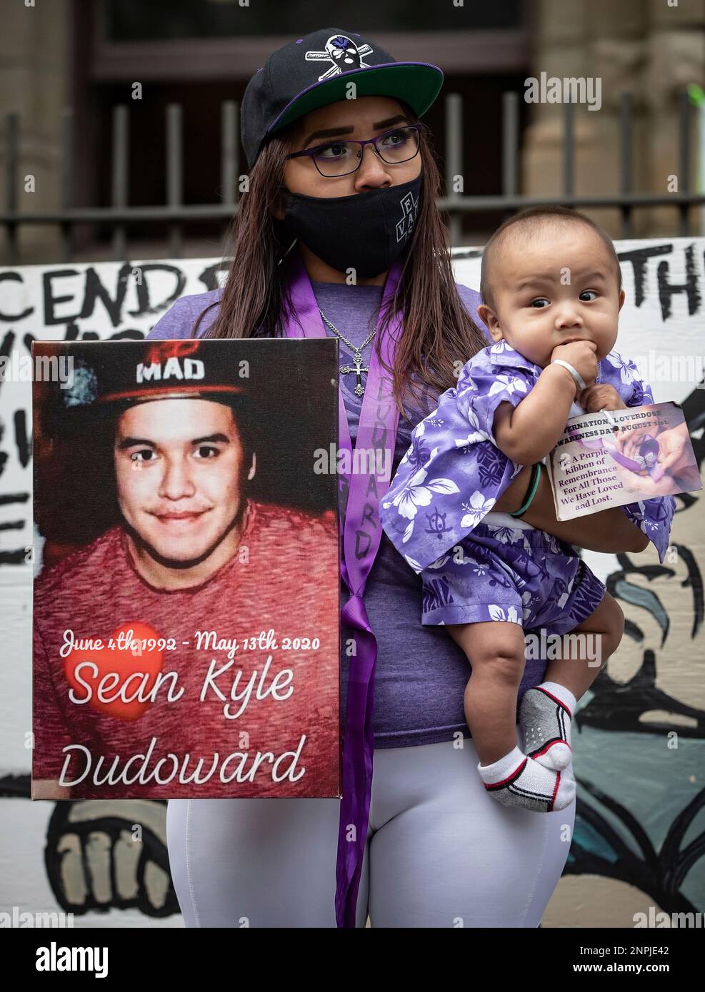 Katelynn Innes holds her six-month-old son Kaleb Innes and a photo of ...