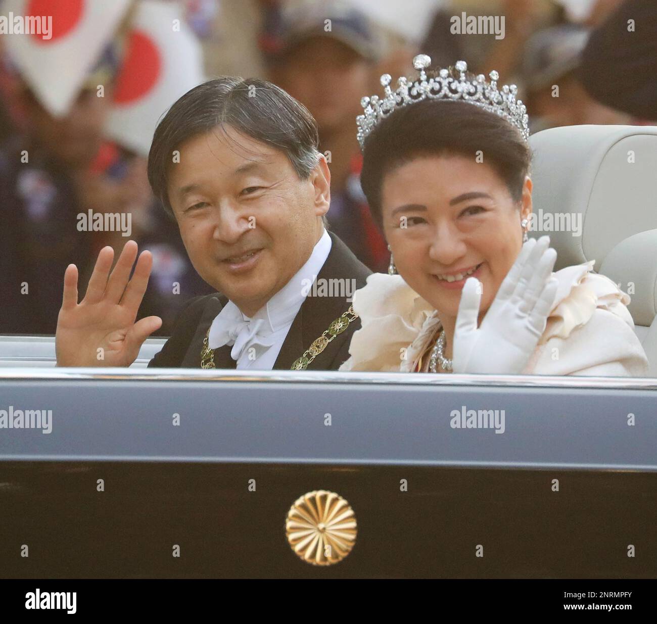 Japan's Emperor Naruhito and Empress Masako wave hand on a convertible ...