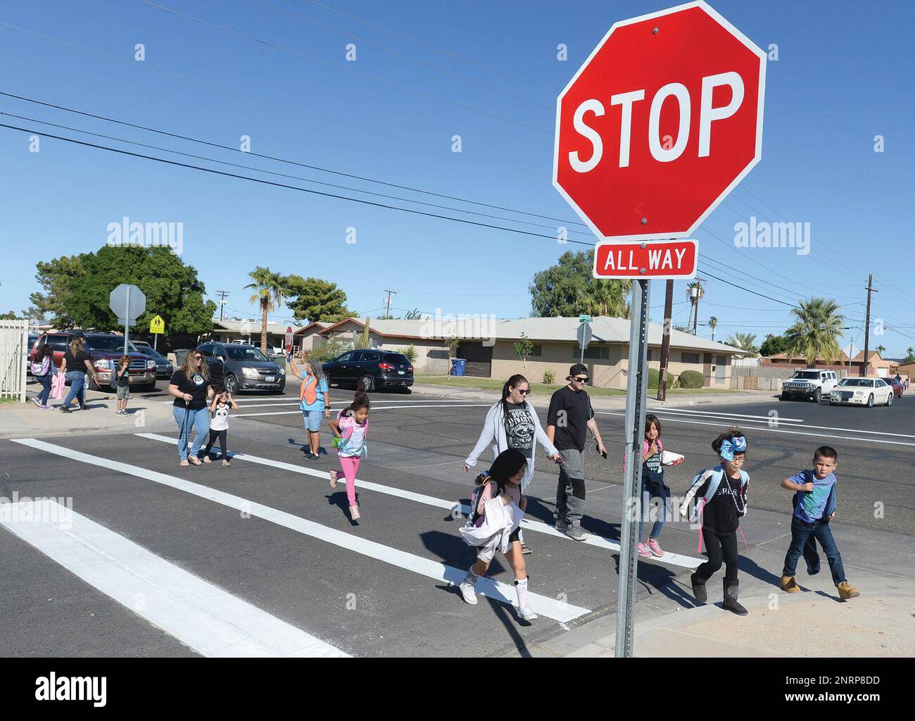 Adults and children cross 17th Street at the intersection with 8th ...