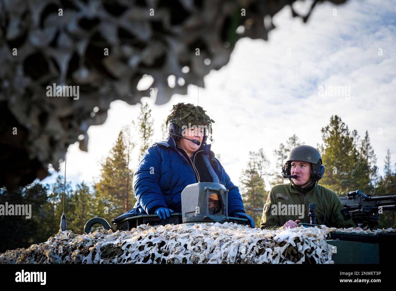 Norway's Prime Minister Erna Solberg, left, drives in a Leopard 2 ...