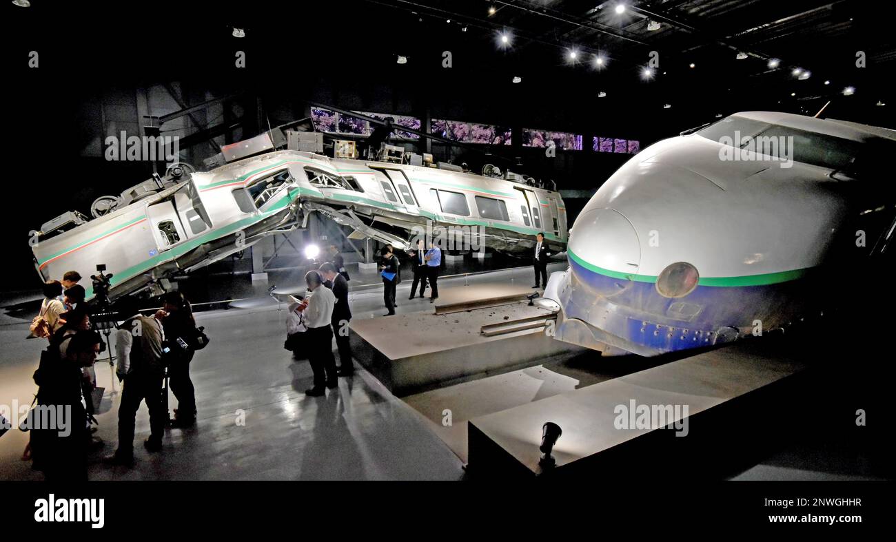Damaged Joban Line train (L) and Shinkansen bullet train are placed at ...