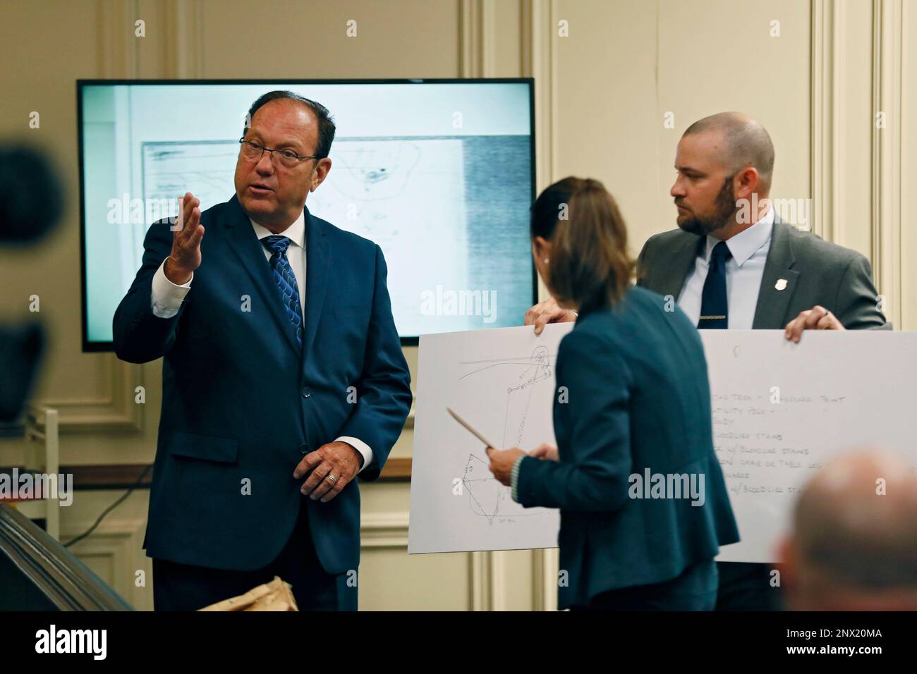 Larry Peterson, left, a GBI forensic investigator, testifies about ...