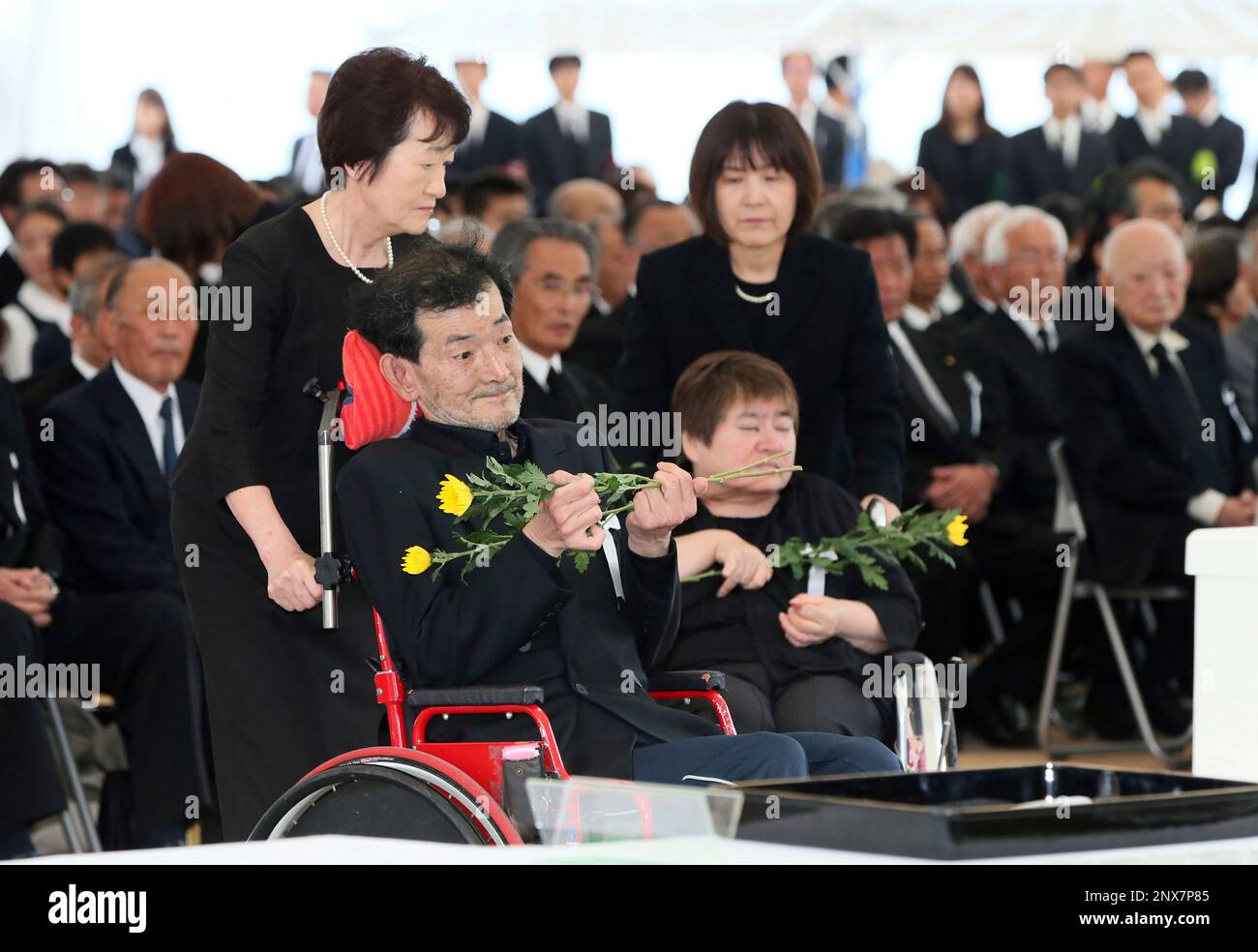 About 700 people including patients offer flowers and pray for the ...
