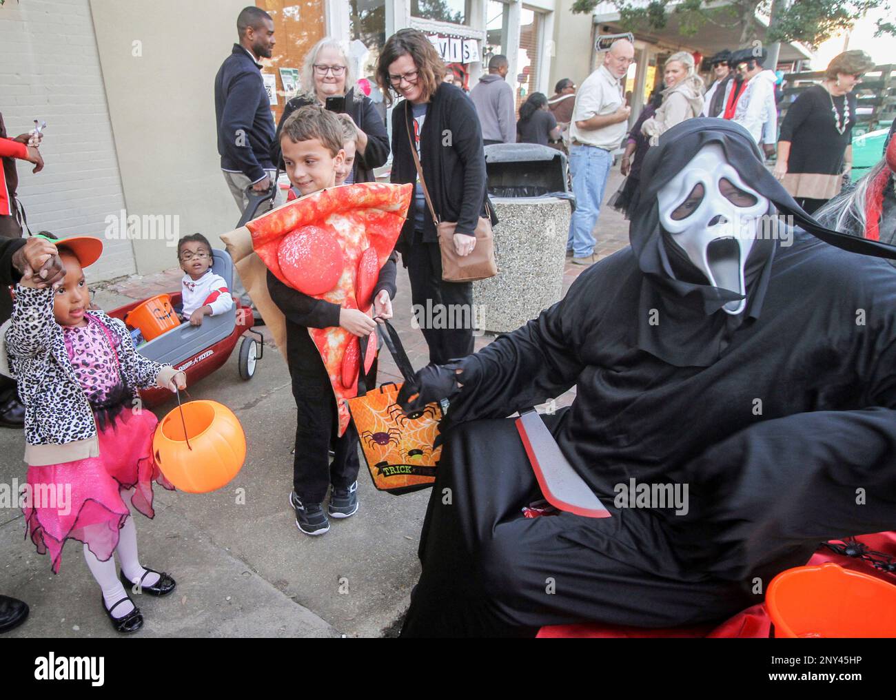 Frank Dungan, right, plays a Halloween trick on children before he ...