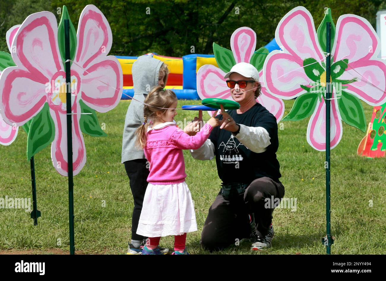 Gary Auerbach, aka the Frisbee Guy, helps his grandchildren Silas Huber ...