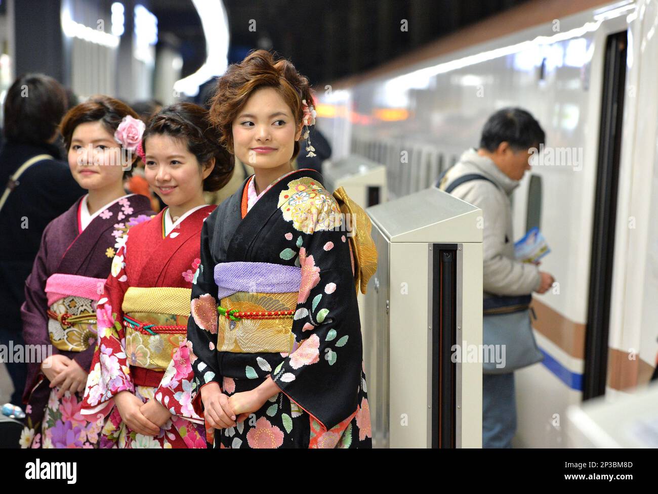 Kimono-clad attendances welcome the passengers of the first bullet ...
