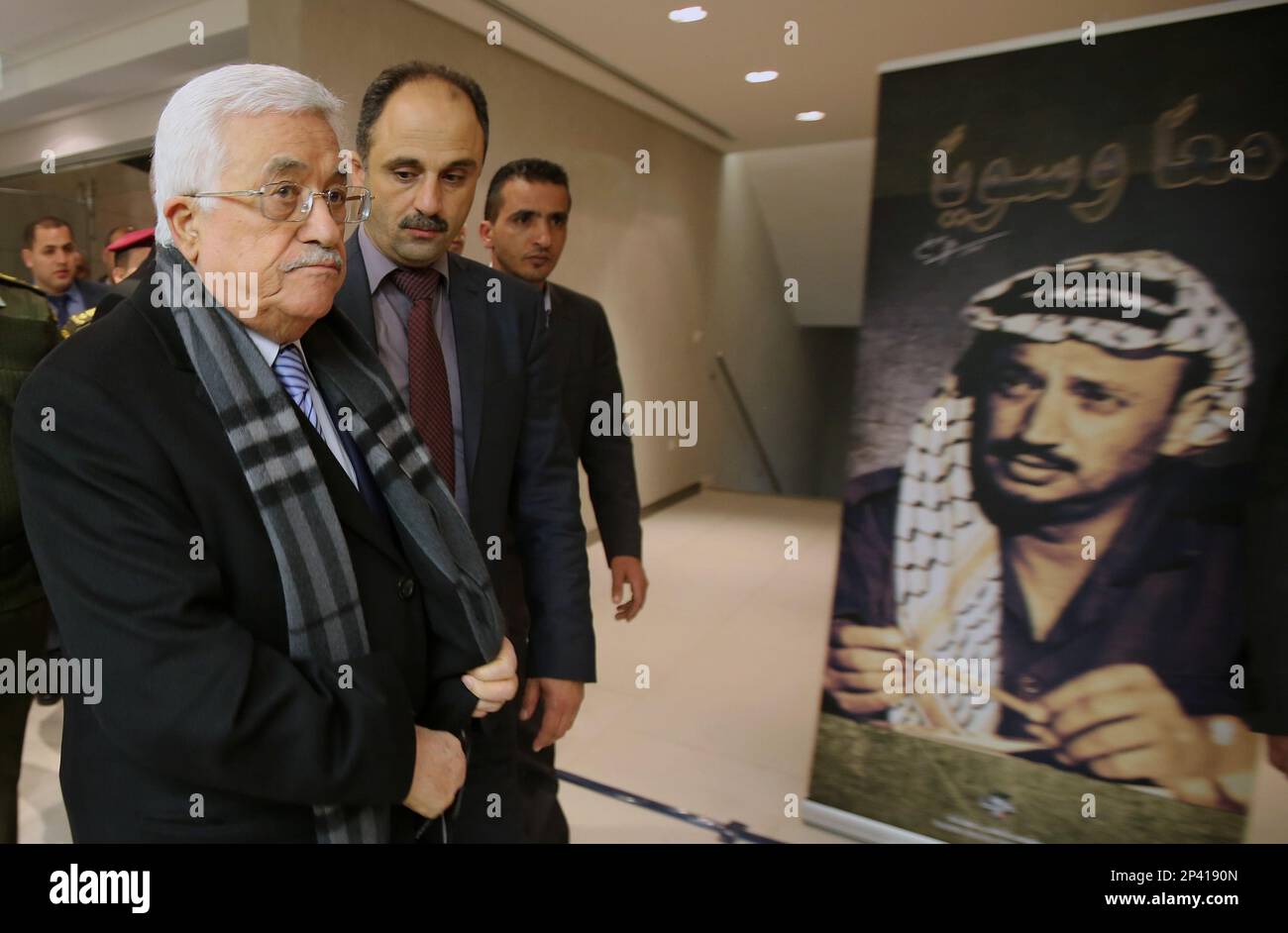 Palestinian President Mahmoud Abbas, left, arrives for the opening of a ...