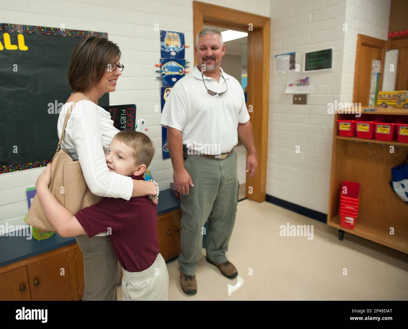 Kindergartener Grant Arthur, 5, says goodbye to his parents Michele and ...