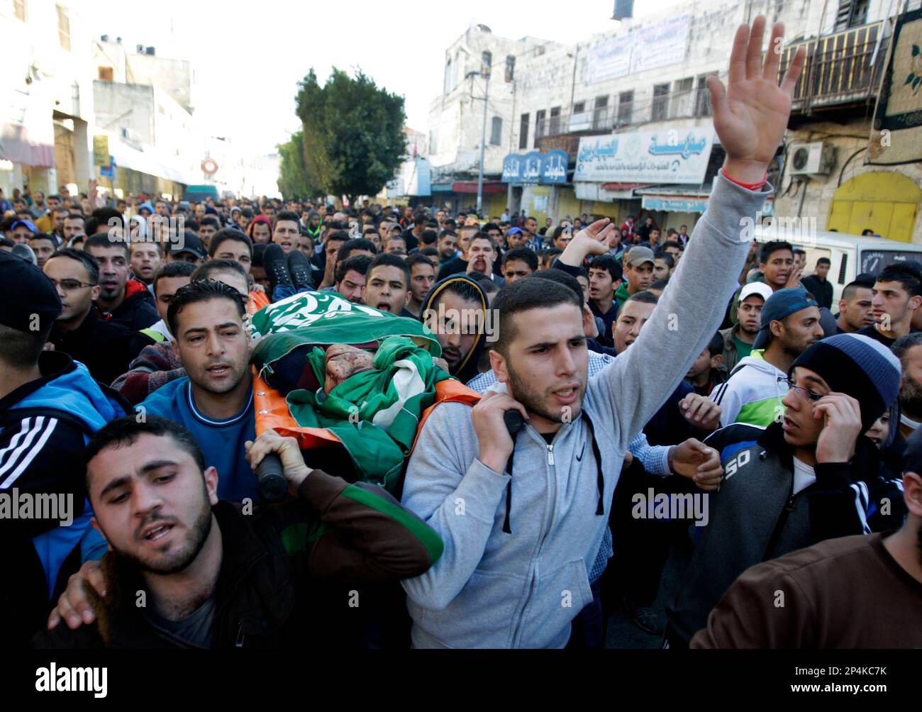 Palestinians carry the body of Hamza Abu el-Heija, who was killed in a ...