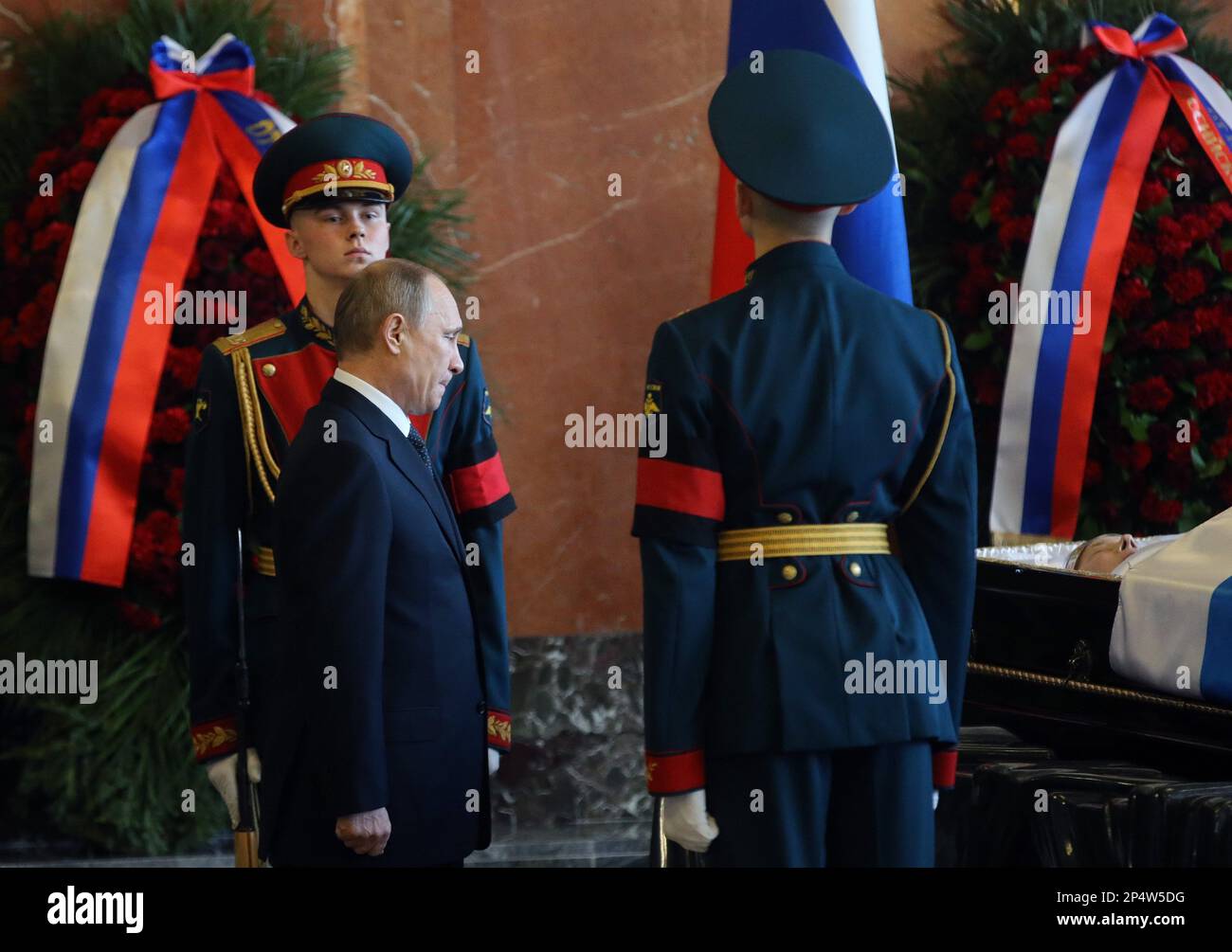 Russian President Vladimir Putin, left, pays his respects to Russian ...