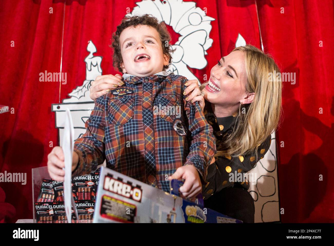 Aidan Scott, 7, smiles after receiving a present from actress Hilary ...