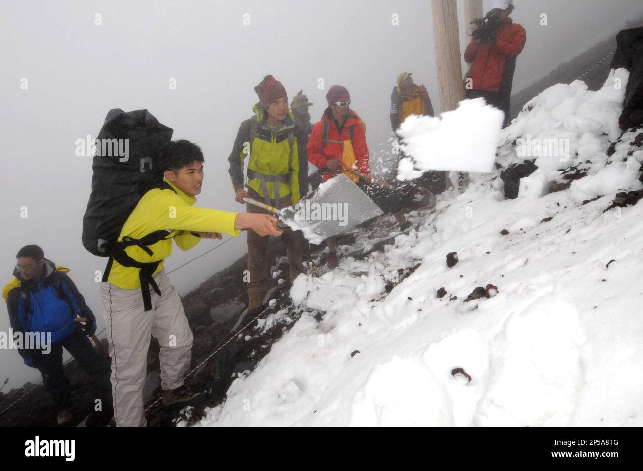 People shovel snow near the ninth station of Mu. Fuji Yoshida-guchi ...
