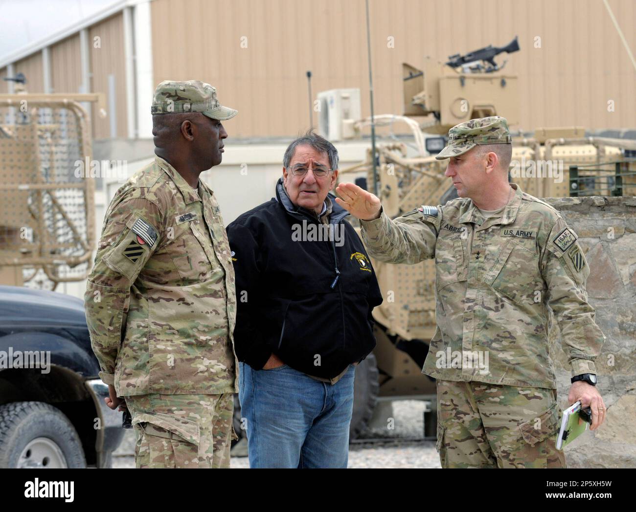 U.S. Defense Secretary Leon Panetta, center, talks with Army Maj. Gen. Robert Abrams, right, and ...