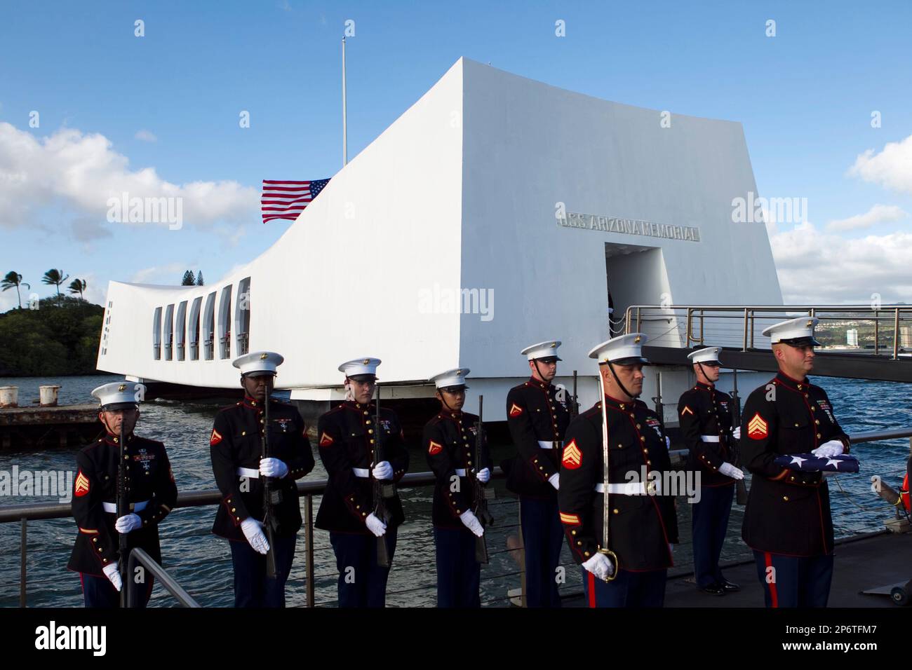 U.S. Marines stand at attention as the family of Pfc. Frank R. Cabiness ...