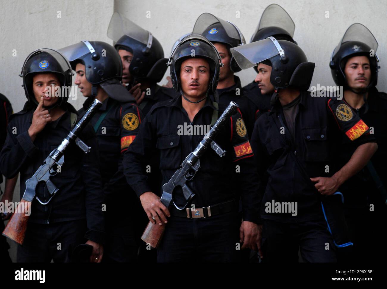 Egyptian riot police take their positions after stone throwing clashes ...