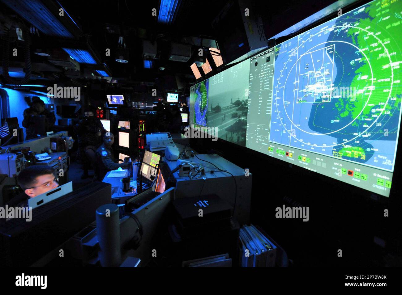 U.S. Navy personnel watch the monitor screens aboard the U.S. Navy's ...