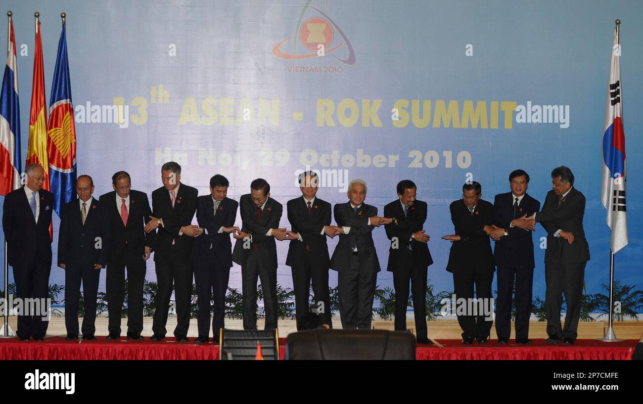 South Korea's President Lee Myung-bak, 6th left, joins hands for a ...