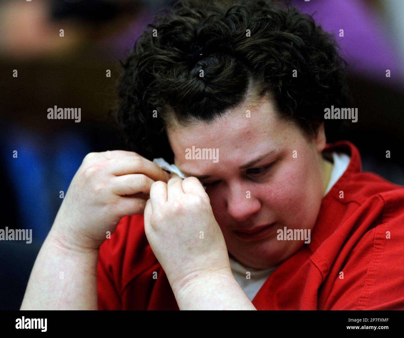 Melissa Huckaby, 29 wipes away tears after watching a multimedia ...