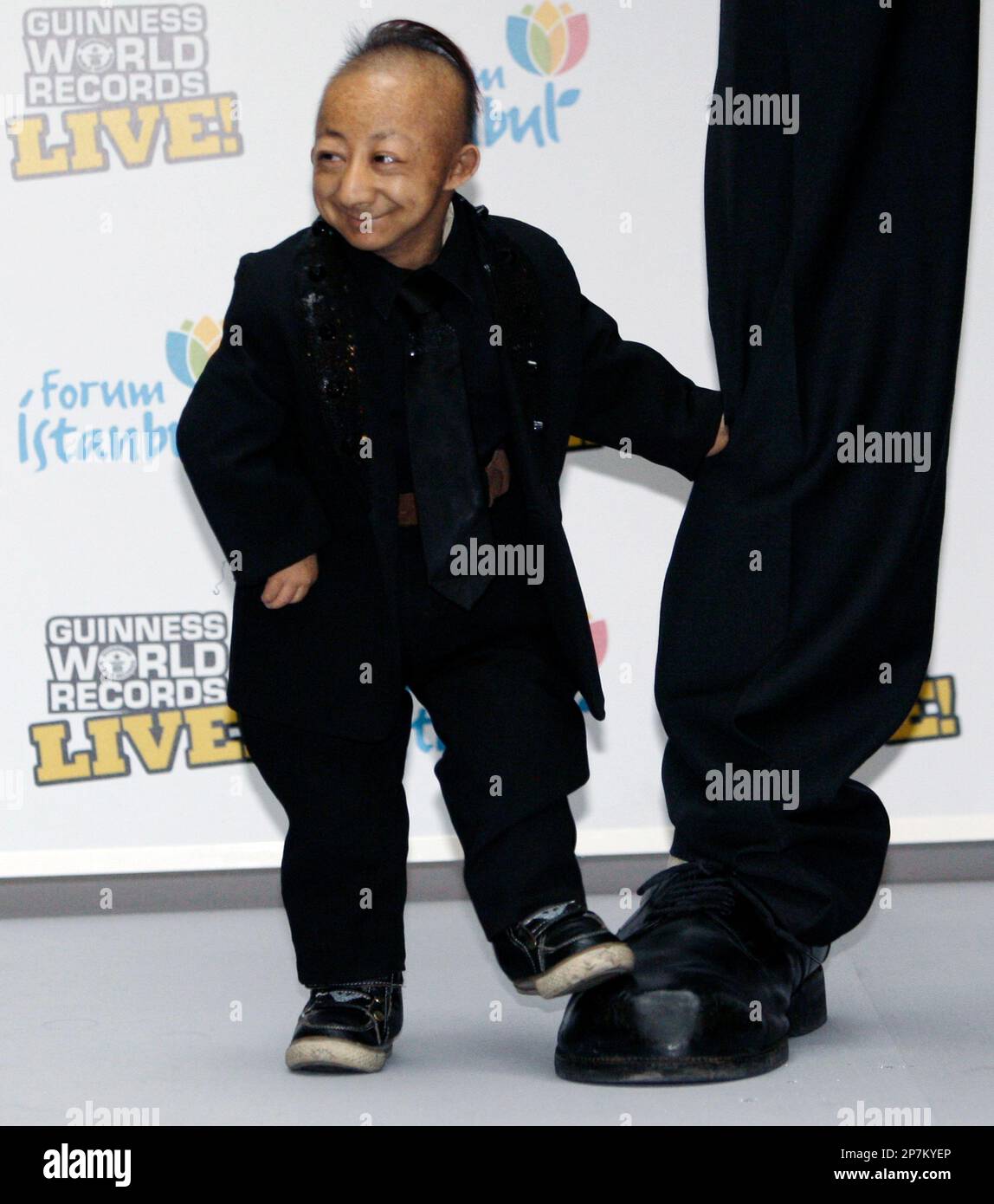 He Pingping of China, 21, holds by a leg of Sultan Kosen of Turkey, 27, during an event ...