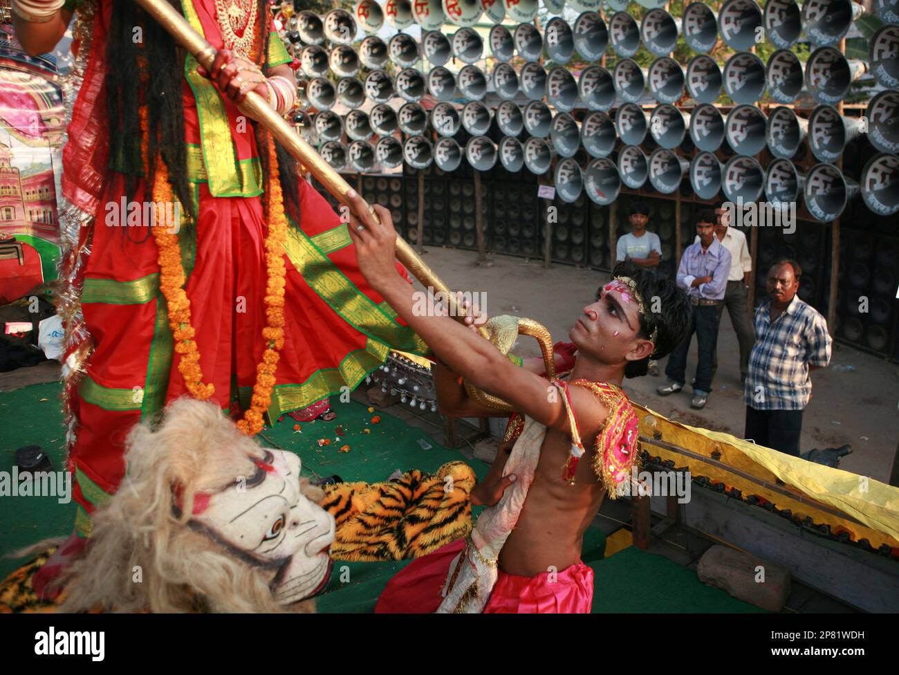 Indian artists dressed as Hindu goddess of valor Durga, left, and demon ...