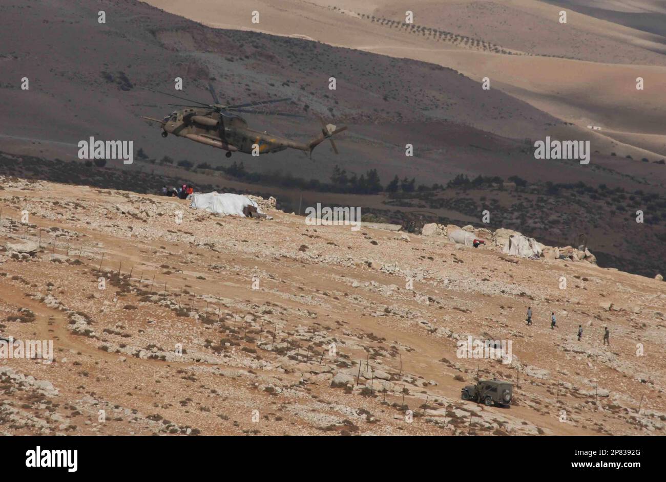 An Israeli air force combat helicopter flies over the crash site of a F ...