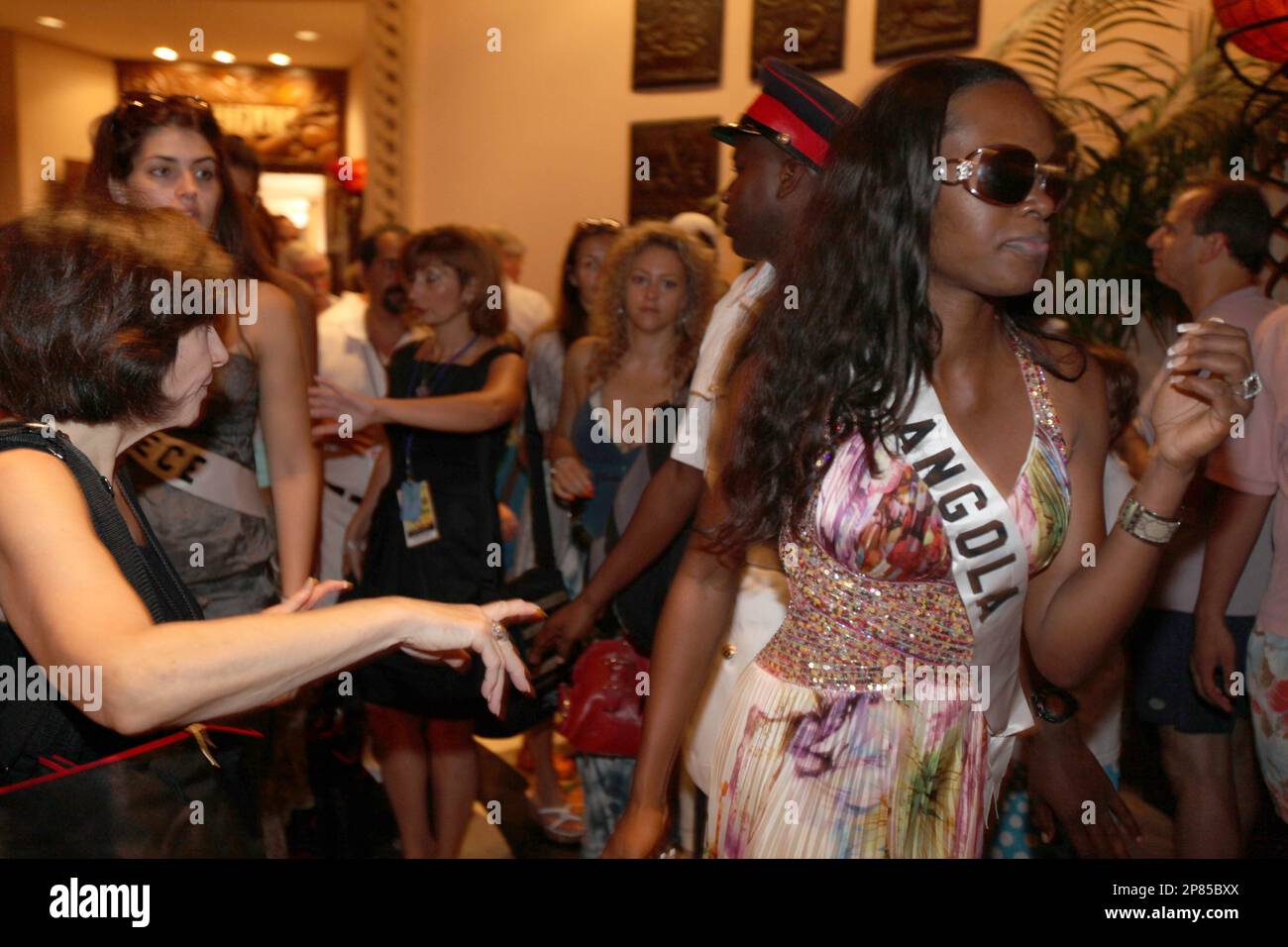 Miss Angola Nelsa Alves, right, walks through the Atlantis resort with ...