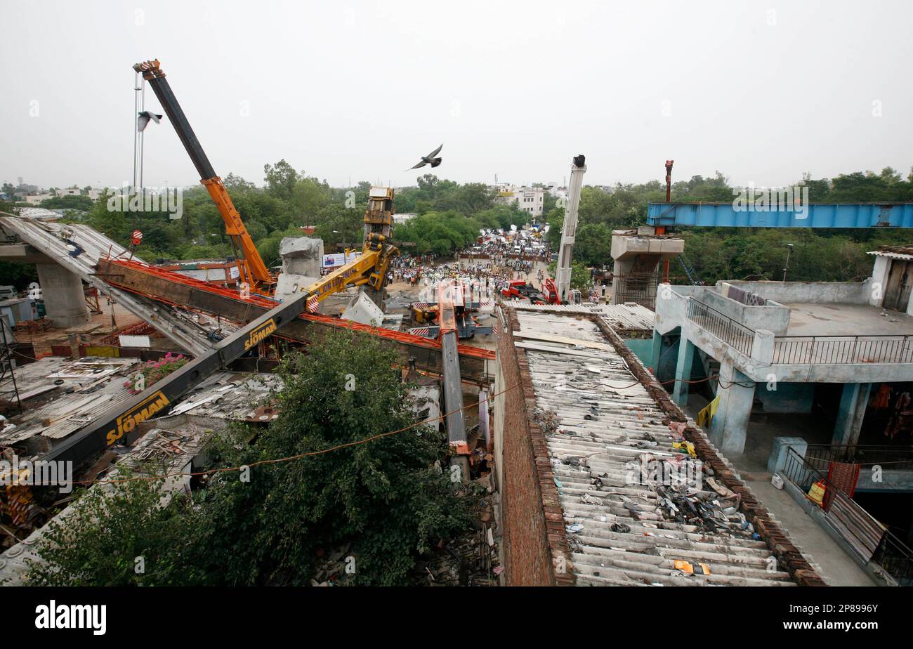 Cranes are seen collapsed at a metro rail construction site in New ...
