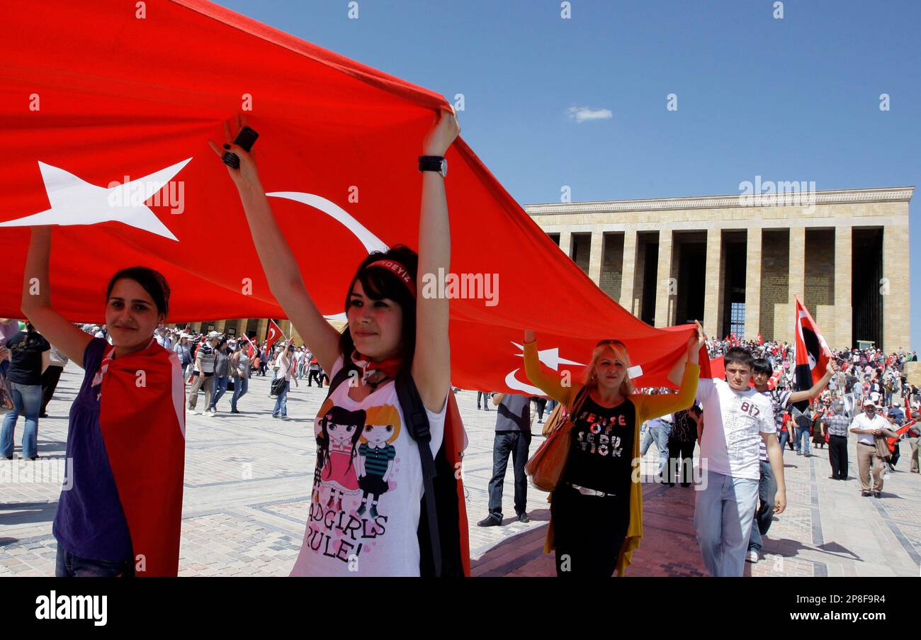 People hold a giant Turkish national flag as tens of thousands of ...