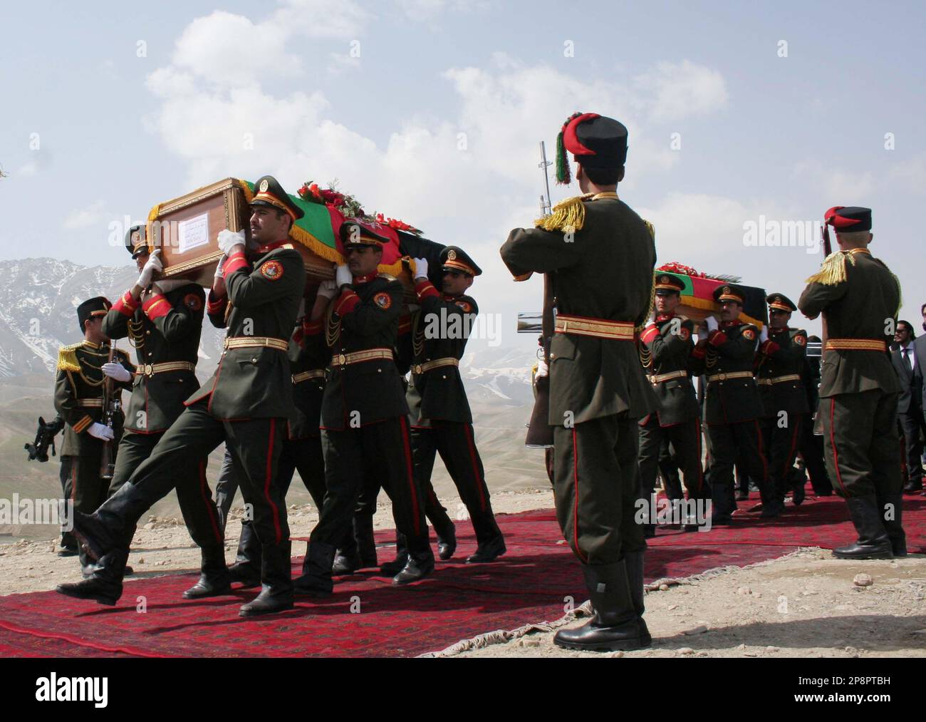 Afghan honor guards carry the coffins of Afghanistan’s first president ...