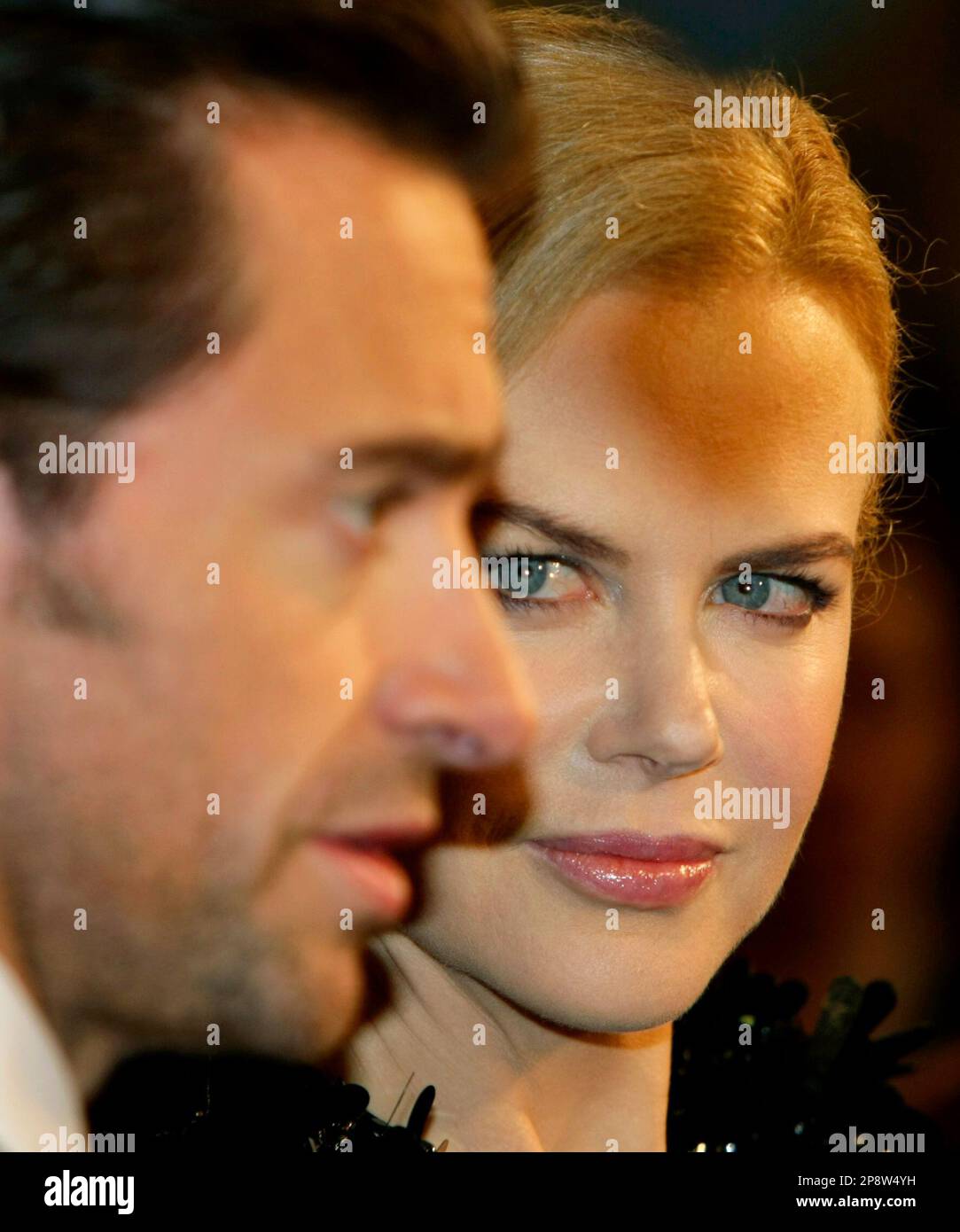 Actress Nicole Kidman looks at Hugh Jackman speaking as they arrive for ...