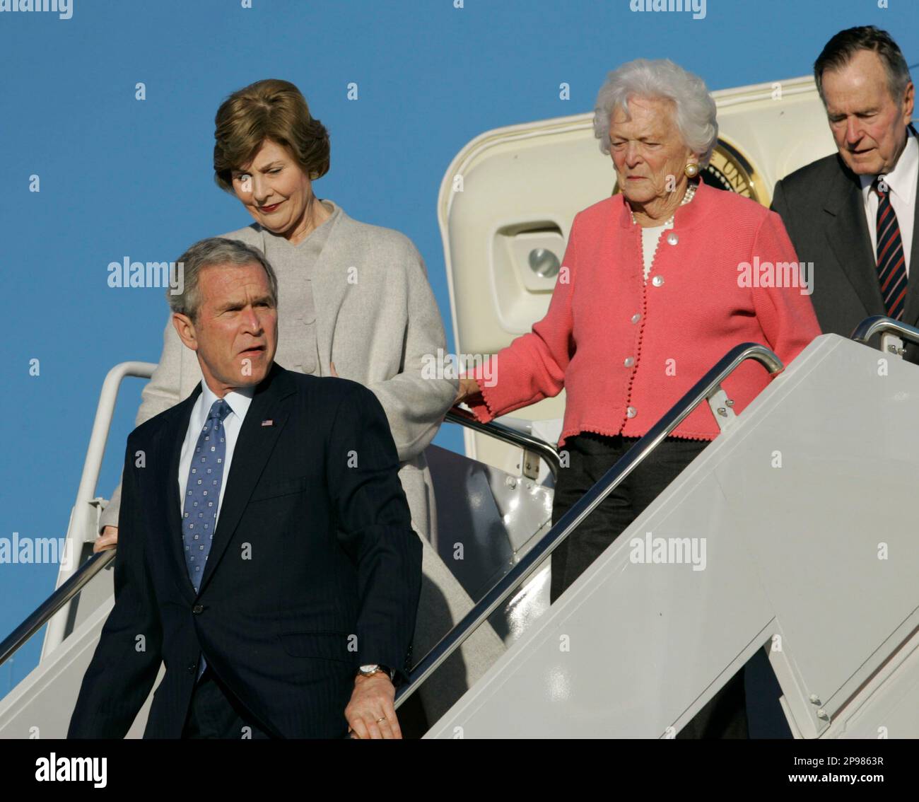 Former President George W. Bush, left, and his wife, Laura Bush, along ...