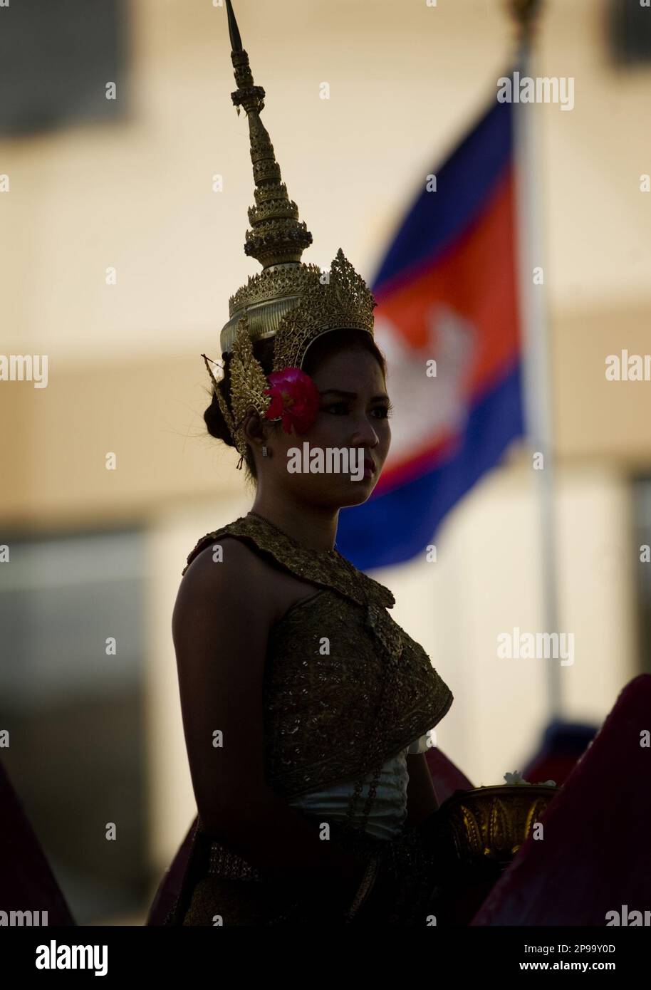 A Cambodian dancer dressed as an "Apsara" is silhouetted against the ...