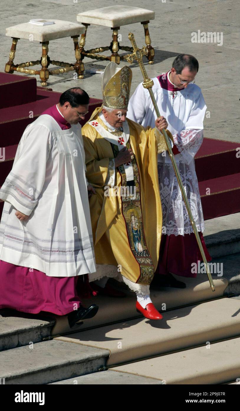 Pope Benedict XVI, centre, is assisted by his aides as he celebrates an ...